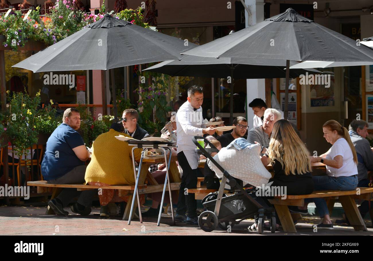 A waiter serves outdoor diners at a restaurant in Santa Fe, New Mexico ...