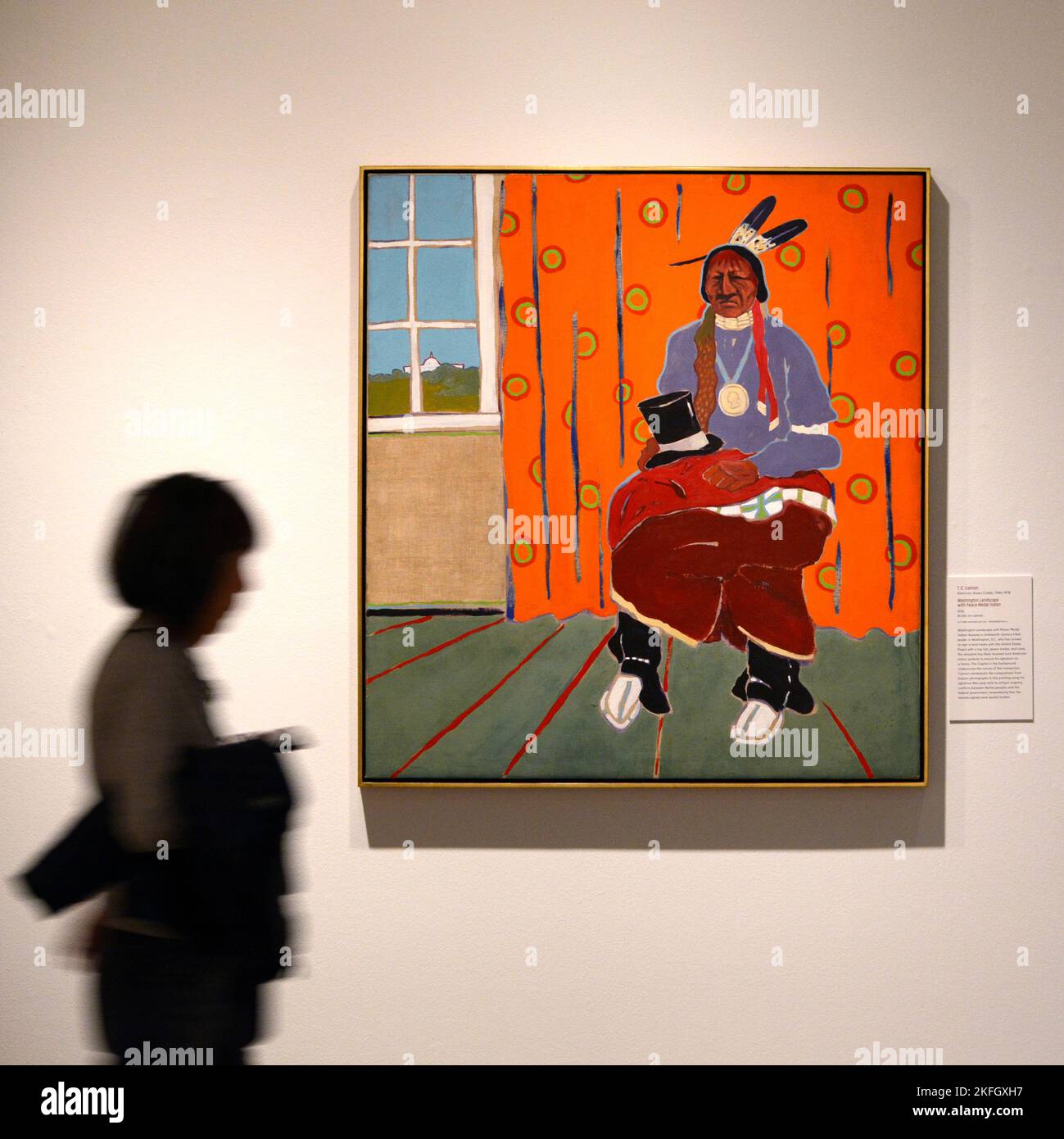 A museum visitor admires a painting by Native-American artist T.C ...