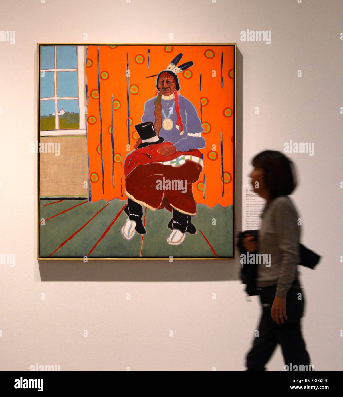 A museum visitor admires a painting by Native-American artist T.C ...