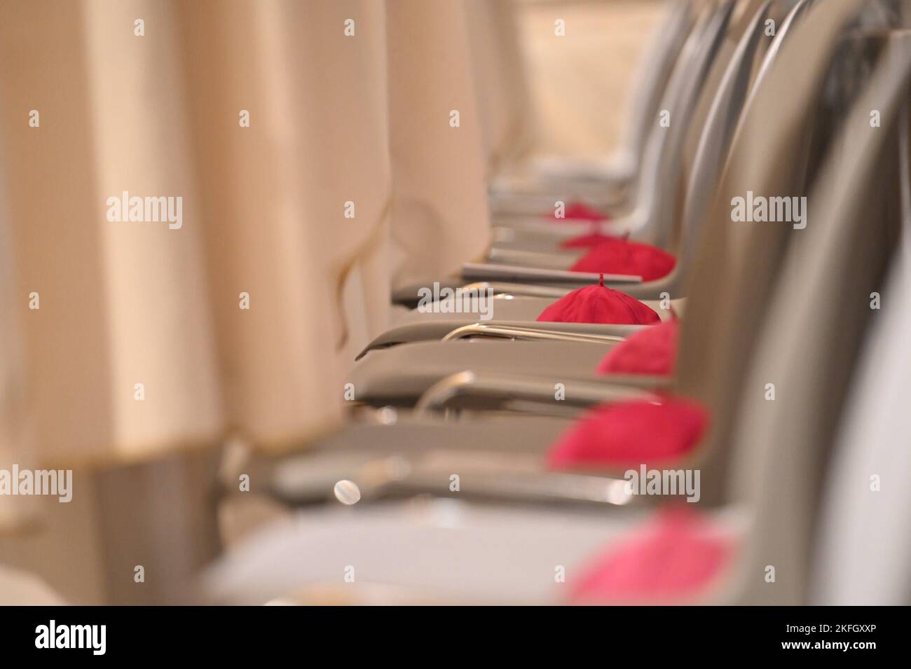 Rom, Italy. 18th Nov, 2022. Bishops' caps lie on chairs in the ...