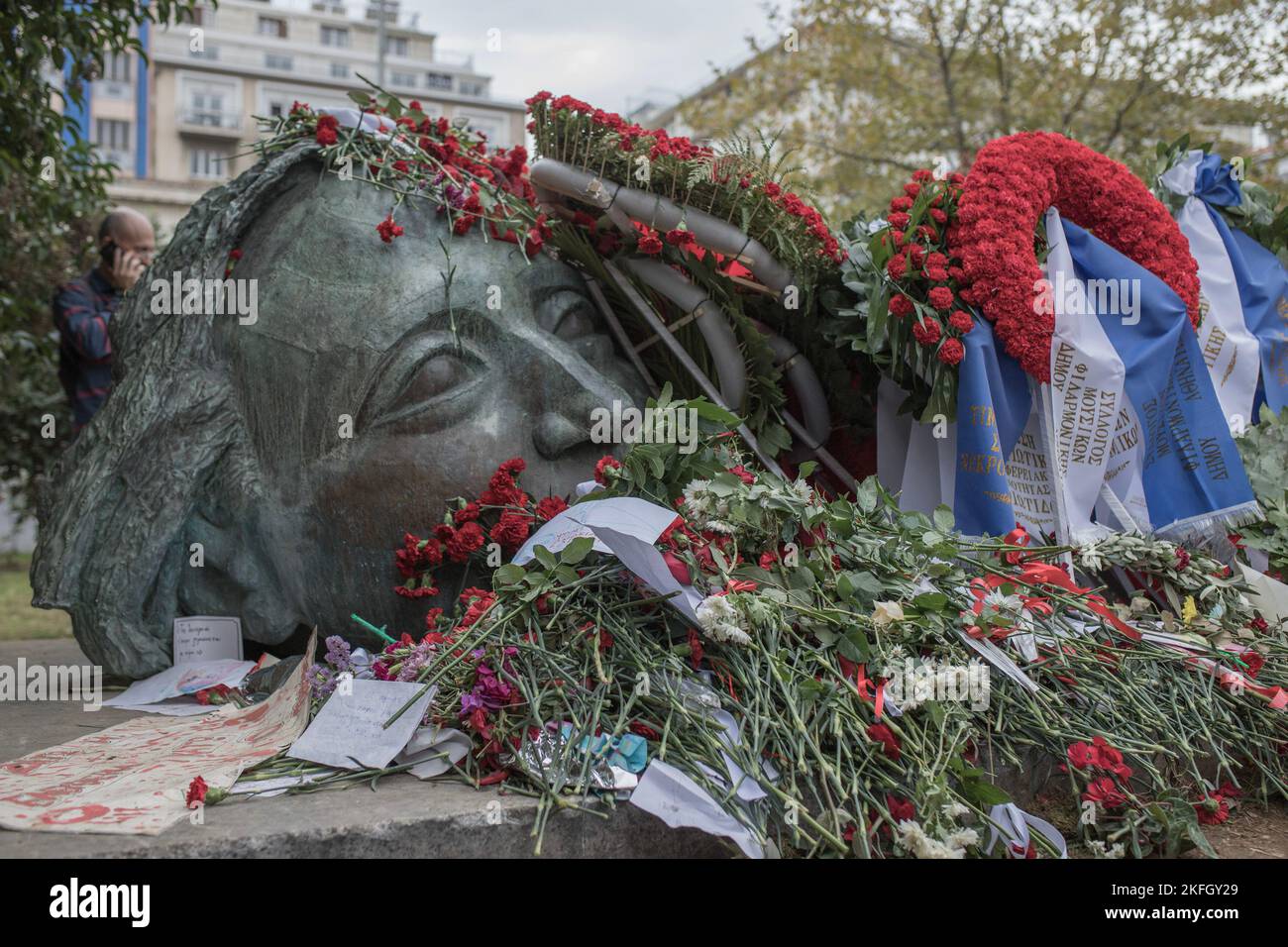 Flowers and the giant bronze head, which was created by Greek sculpture ...