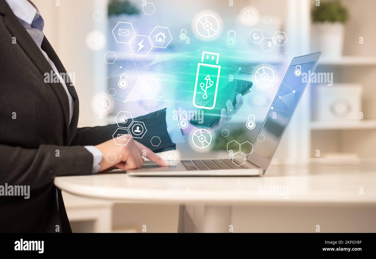 Hands working on laptop with digital icons Stock Photo - Alamy