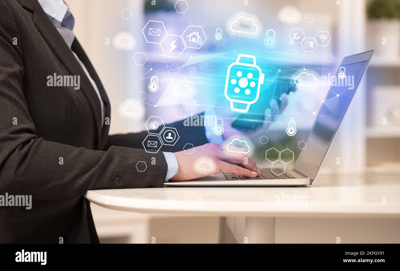 Hands working on laptop with digital icons Stock Photo - Alamy