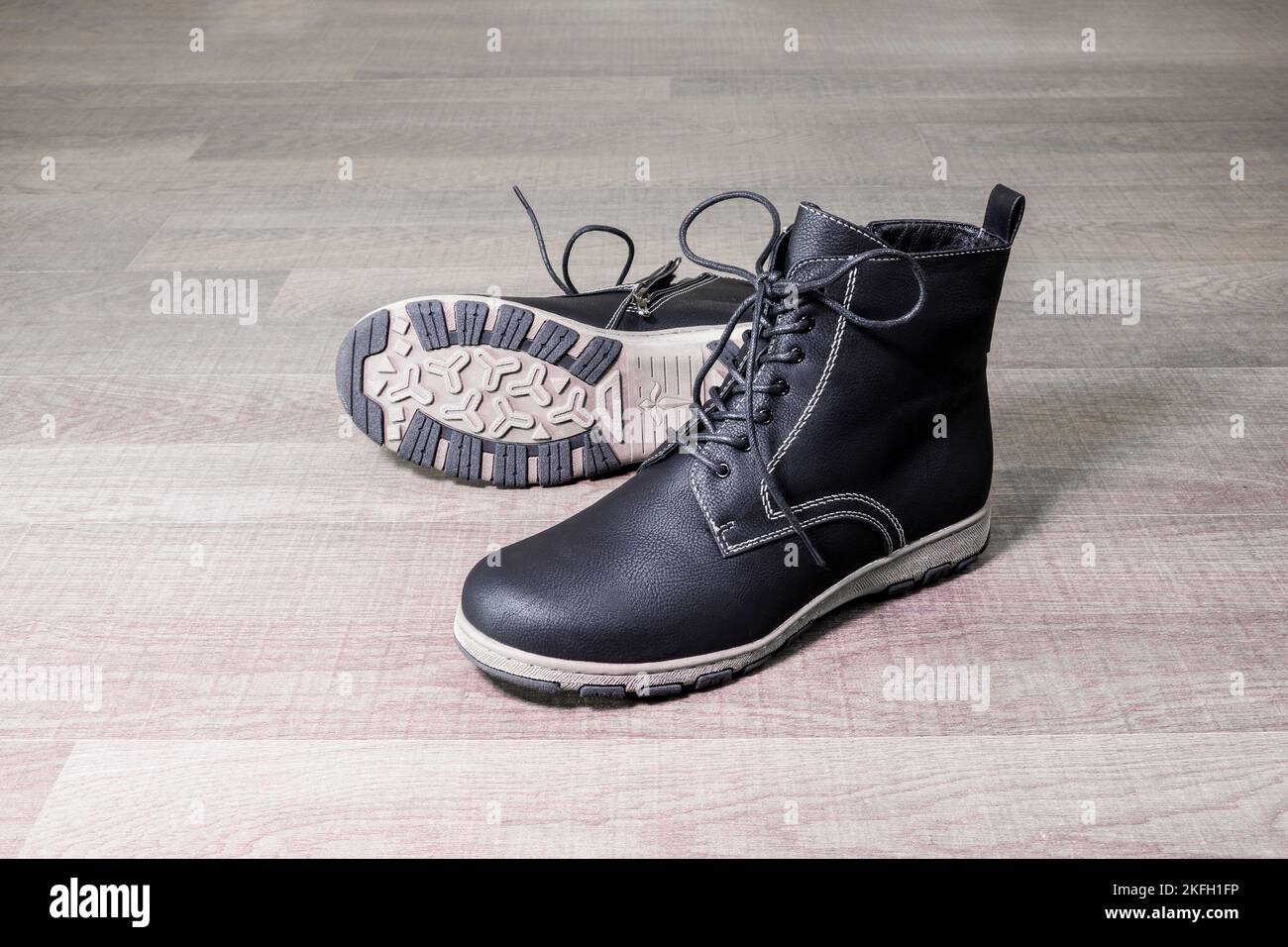 New leather boots lying haphazardly on the floor Stock Photo - Alamy