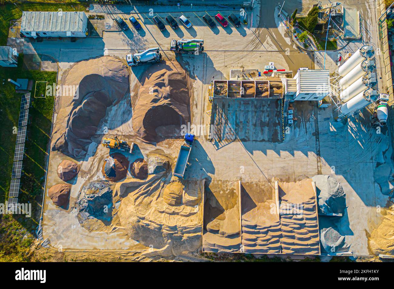 Trucks and tippers parked at open pit sand mining. Aerial view of ...