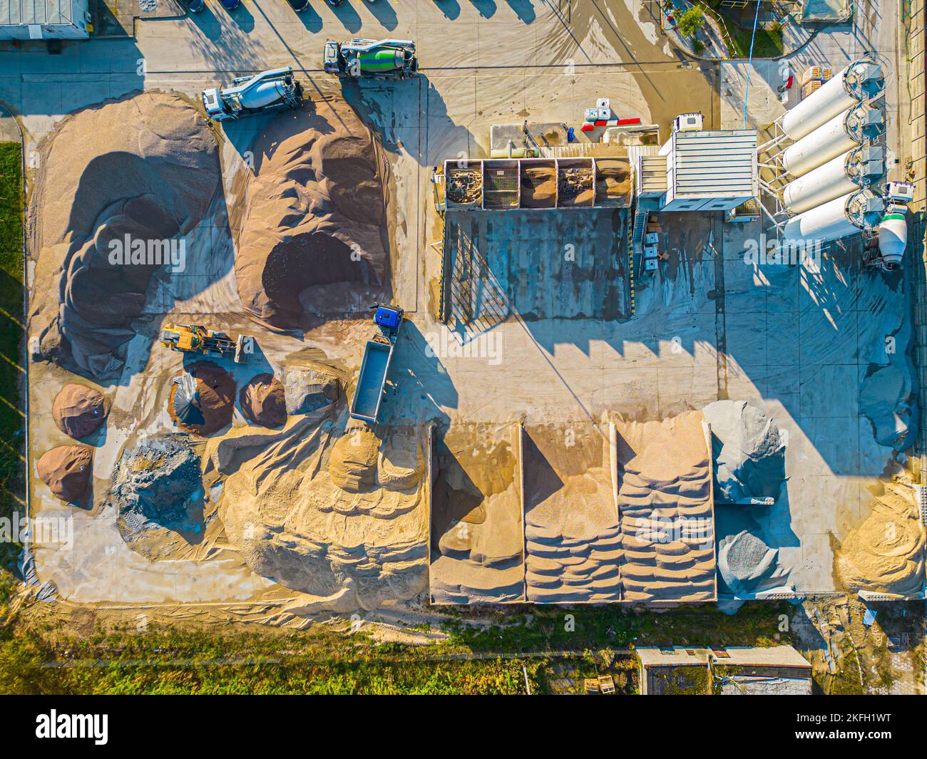 Trucks and tippers parked at open pit sand mining. Aerial view of ...