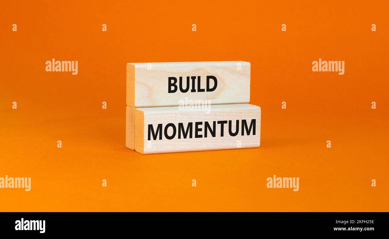Build momentum symbol. Concept words Build momentum on wooden blocks ...