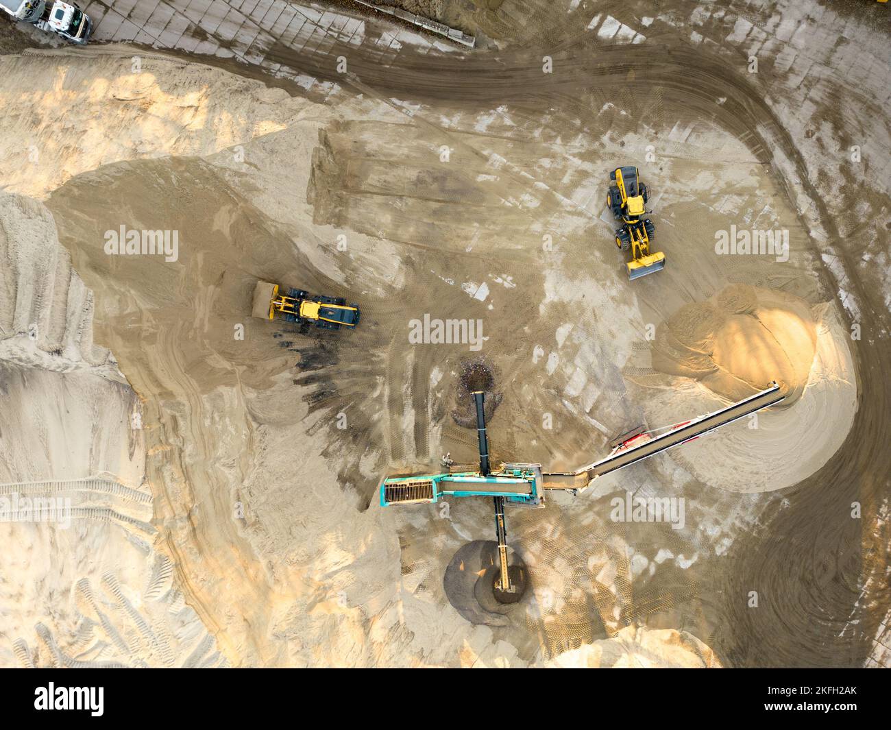 Excavator loading sand into a truck body in Sand quarry, industrial ...