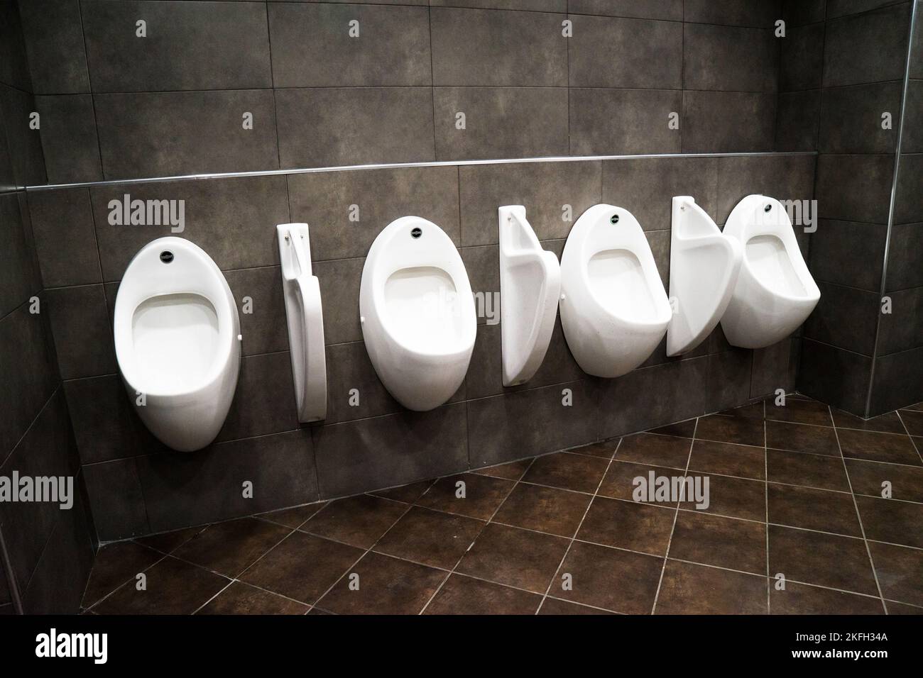 line of white porcelain urinals in public man toilets Stock Photo - Alamy