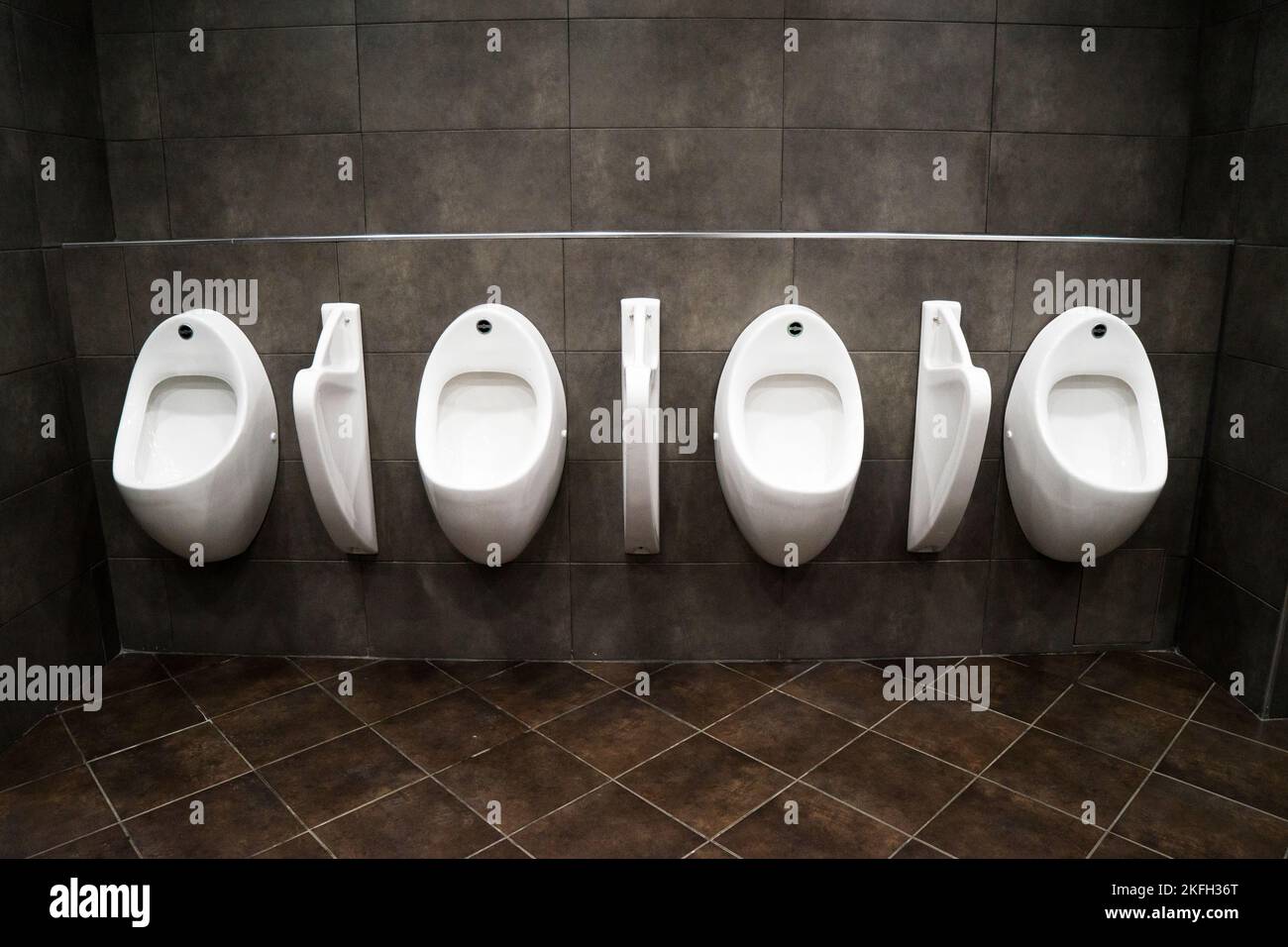 line of white porcelain urinals in public man toilets Stock Photo - Alamy