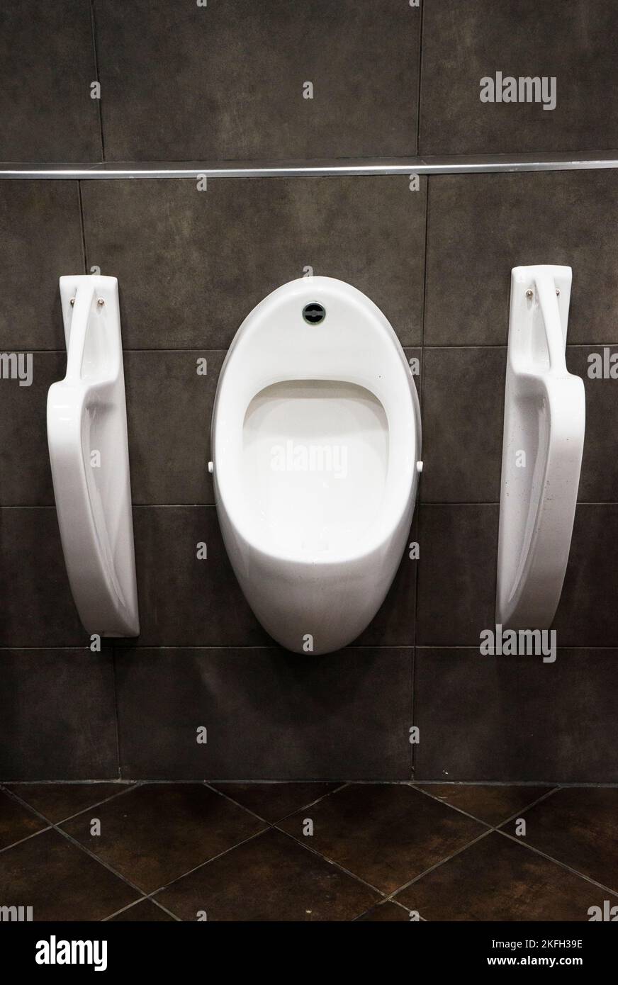 white porcelain urinals in public man toilets Stock Photo - Alamy