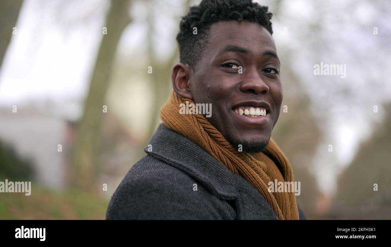 Happy black African man looking at camera smiling portrait during ...