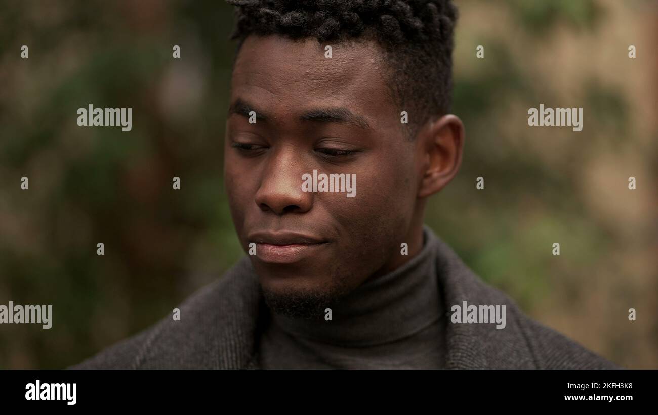 Handsome young black man standing outdoors thinking Stock Photo - Alamy Handsome young black man standing outdoors thinking Stock Photo - Alamy