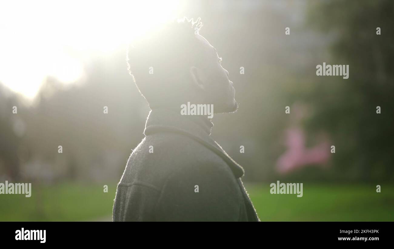 Happy black African man smiling at camera standing outdoors in ...
