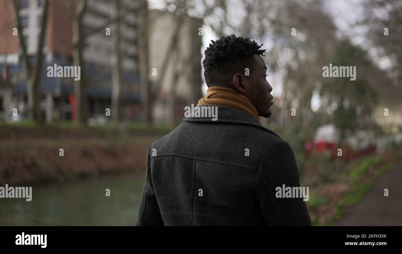 Elegant black man walking outside in nature park during winter season2 ...