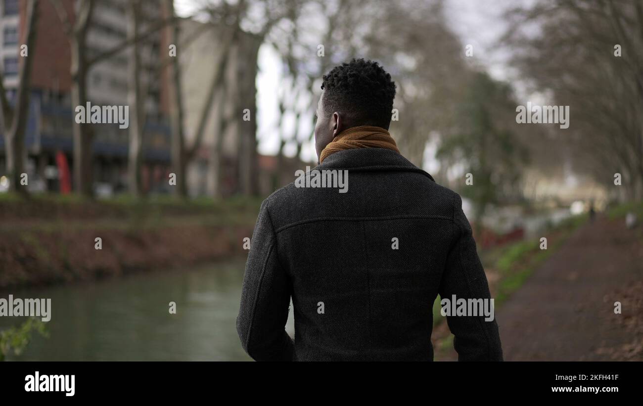 Elegant black man walking outside in nature park during winter season2 ...
