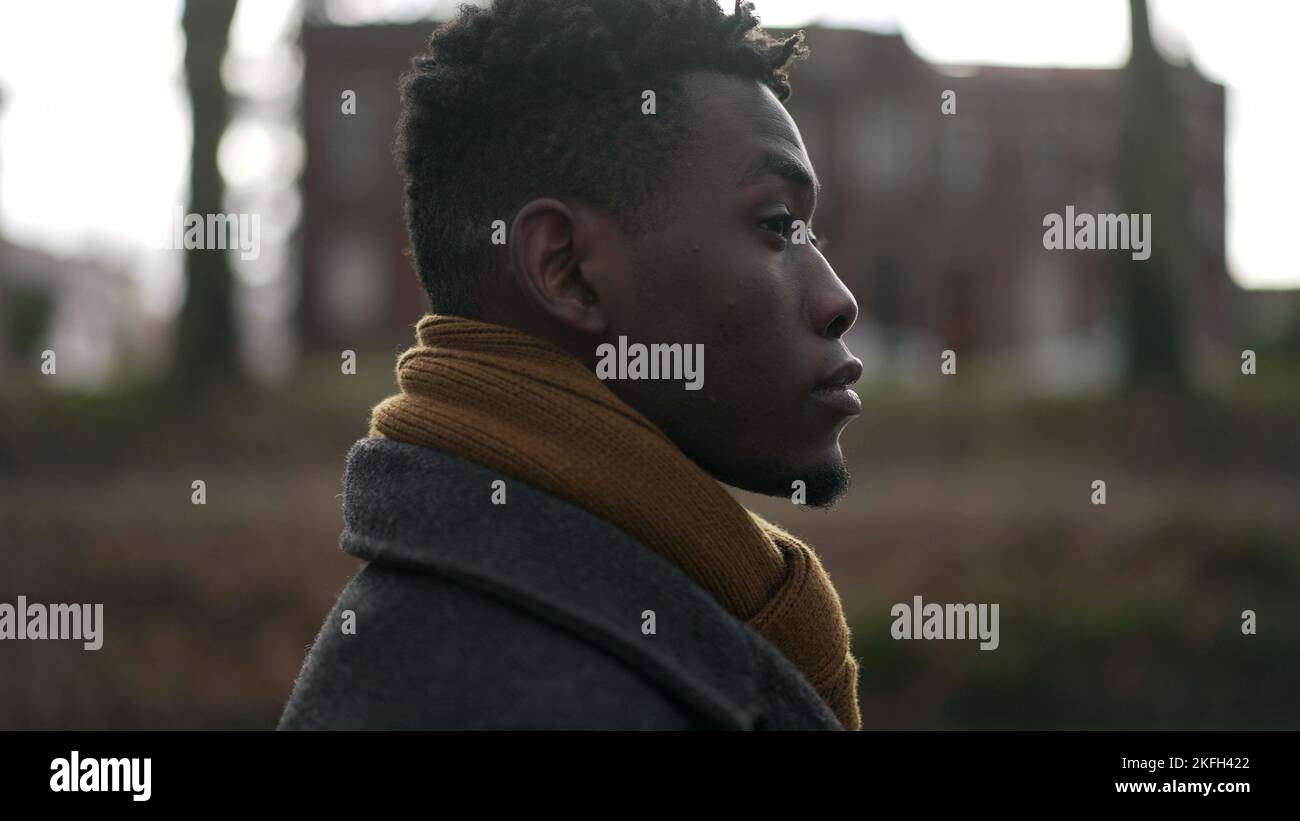 Elegant black man walking outside in nature park during winter season3 ...