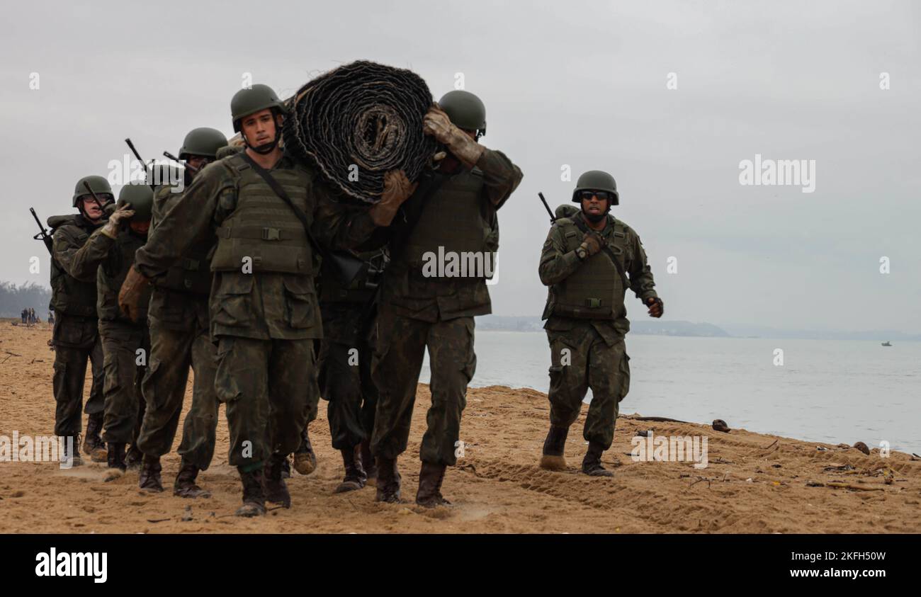 Brazilian Marines transport equipment during an amphibious landing as ...