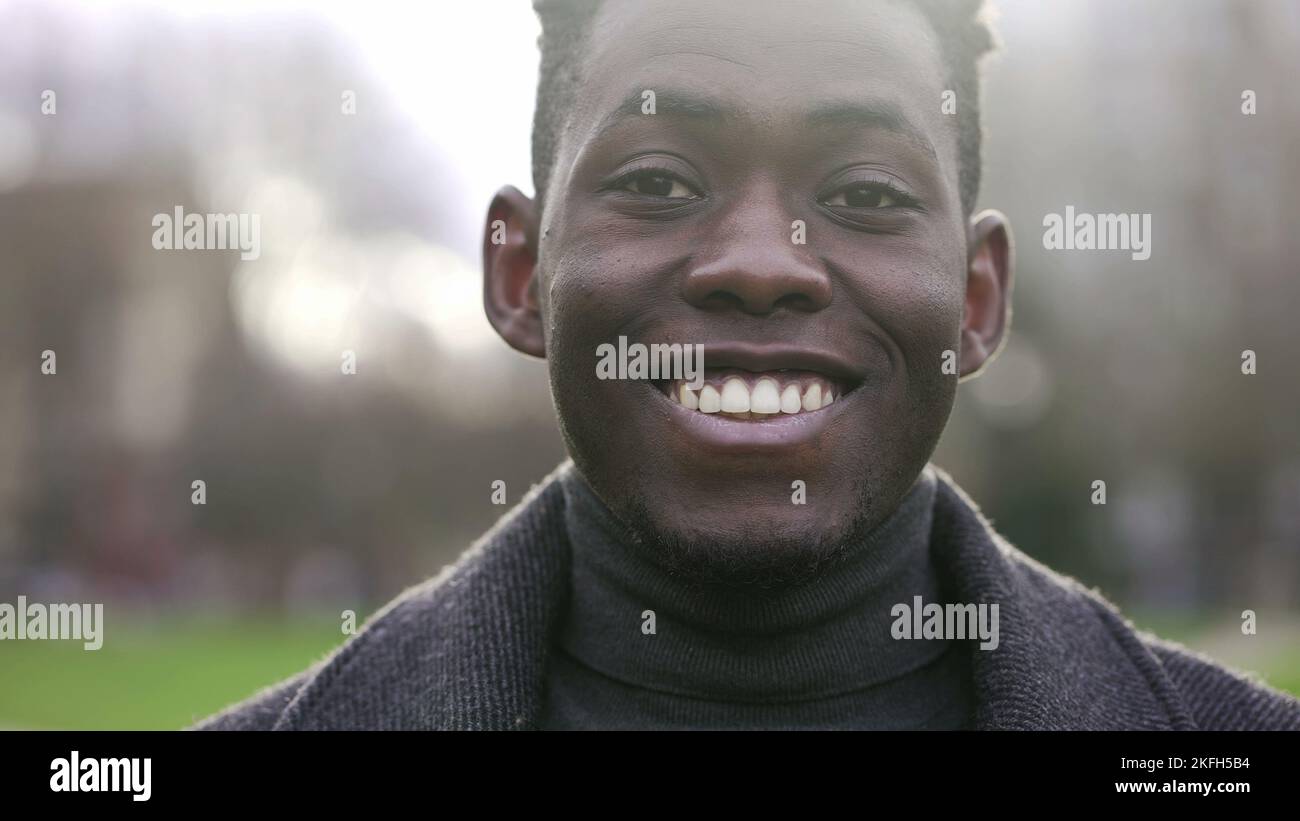 Handsome black African man smiling outside during daylight Stock Photo ...