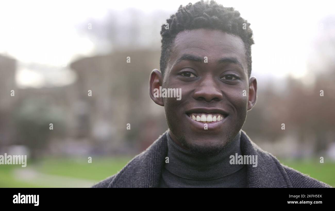 Handsome black African man smiling outside during daylight Stock Photo ...