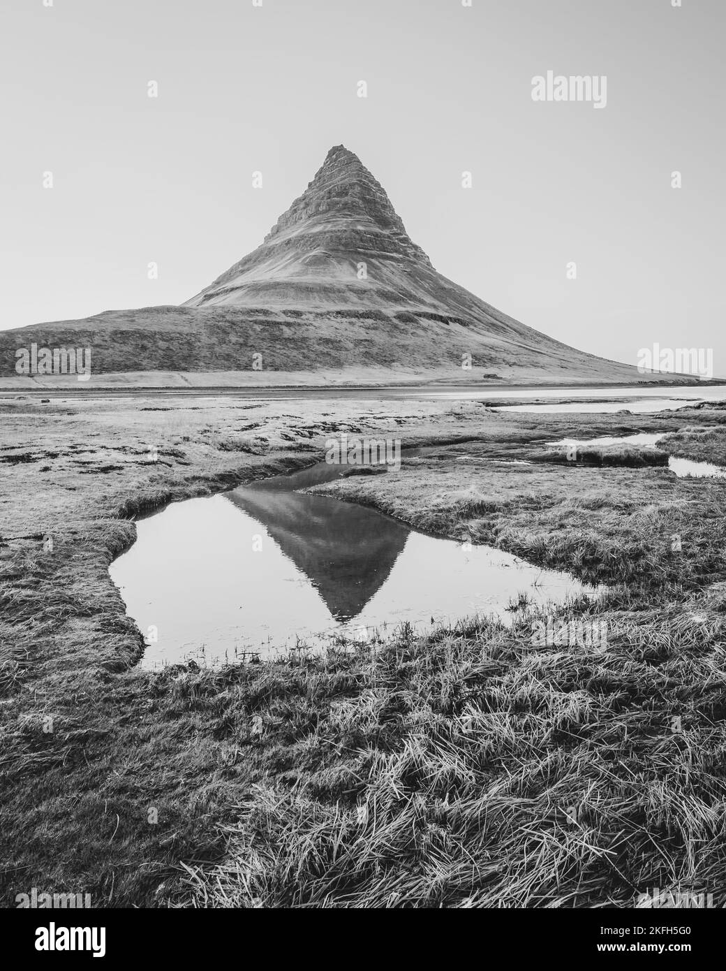 A greyscale vertical shot of the Kirkjufell mountain located in Iceland ...
