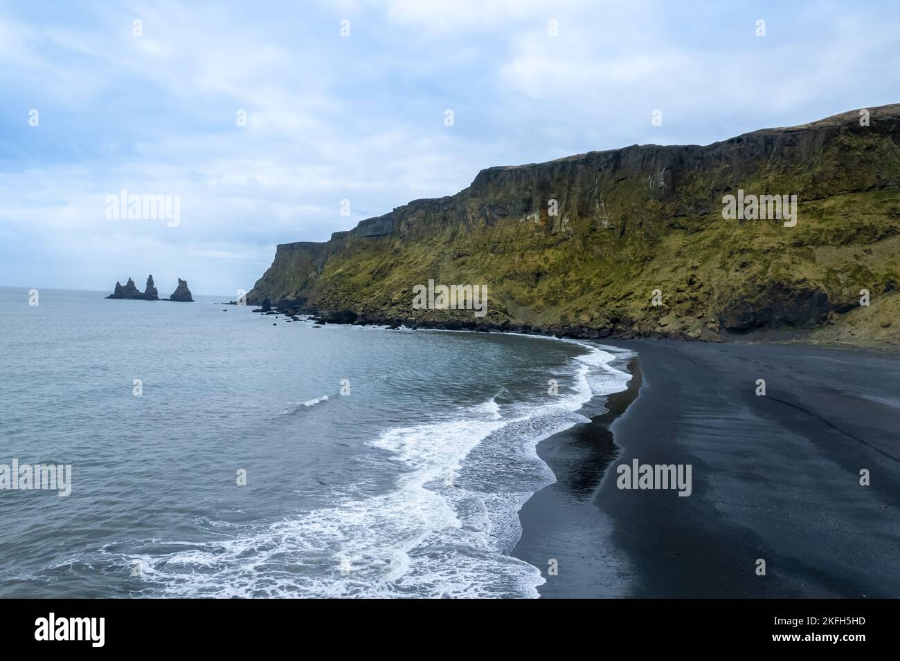 A scenic view of sea waves hitting the shore of a beach in Iceland ...