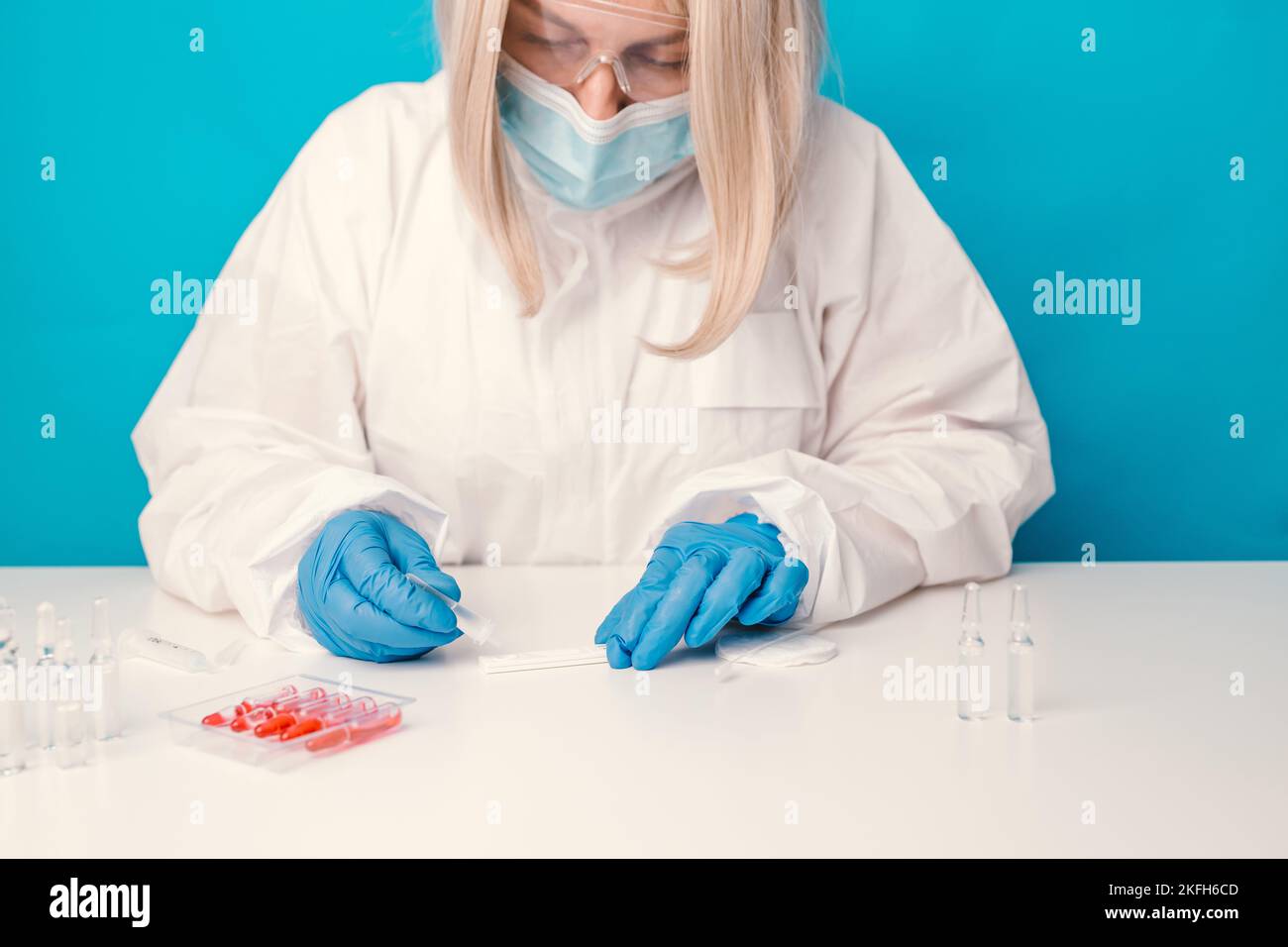 A laboratory employee taking sample PCR microtubes with cotton swab ...