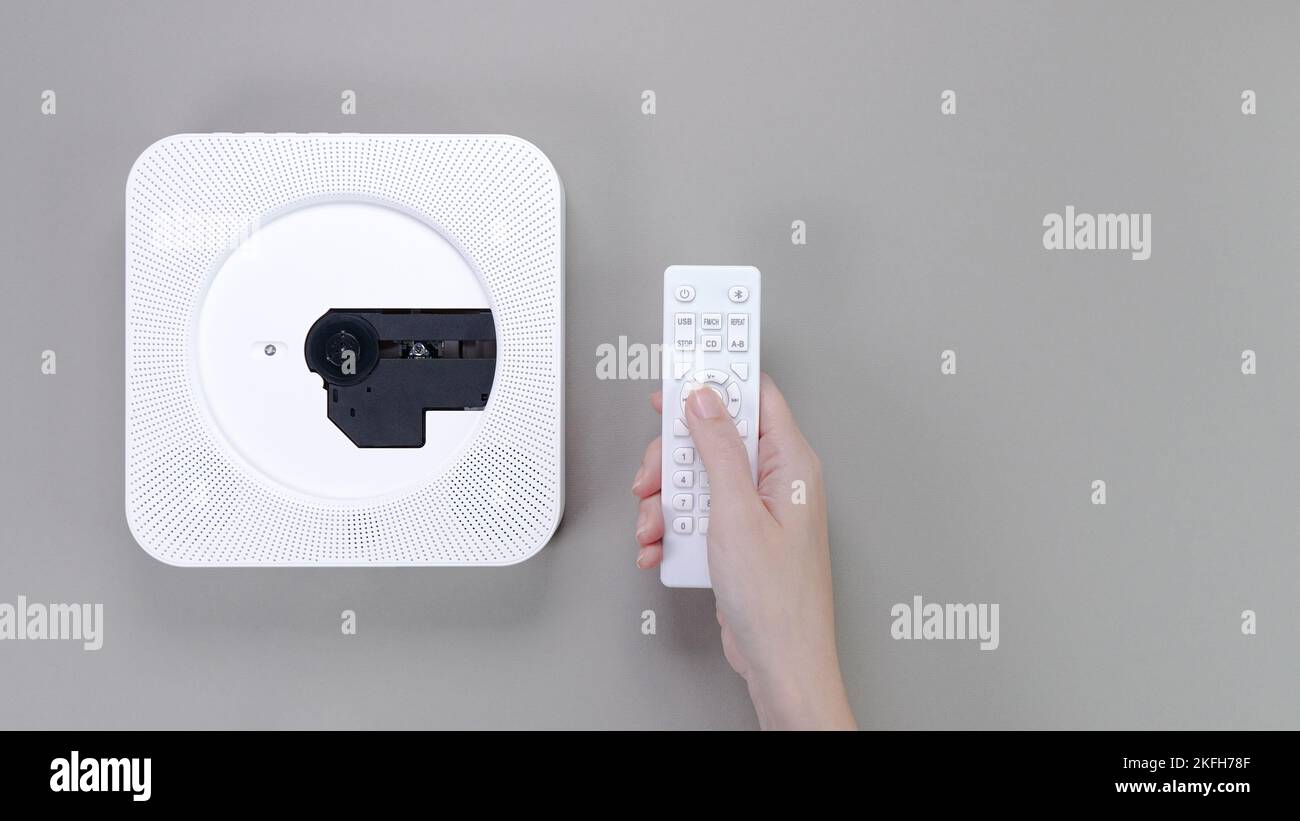 Stylish white portable compact CD player with hand holding controller ...