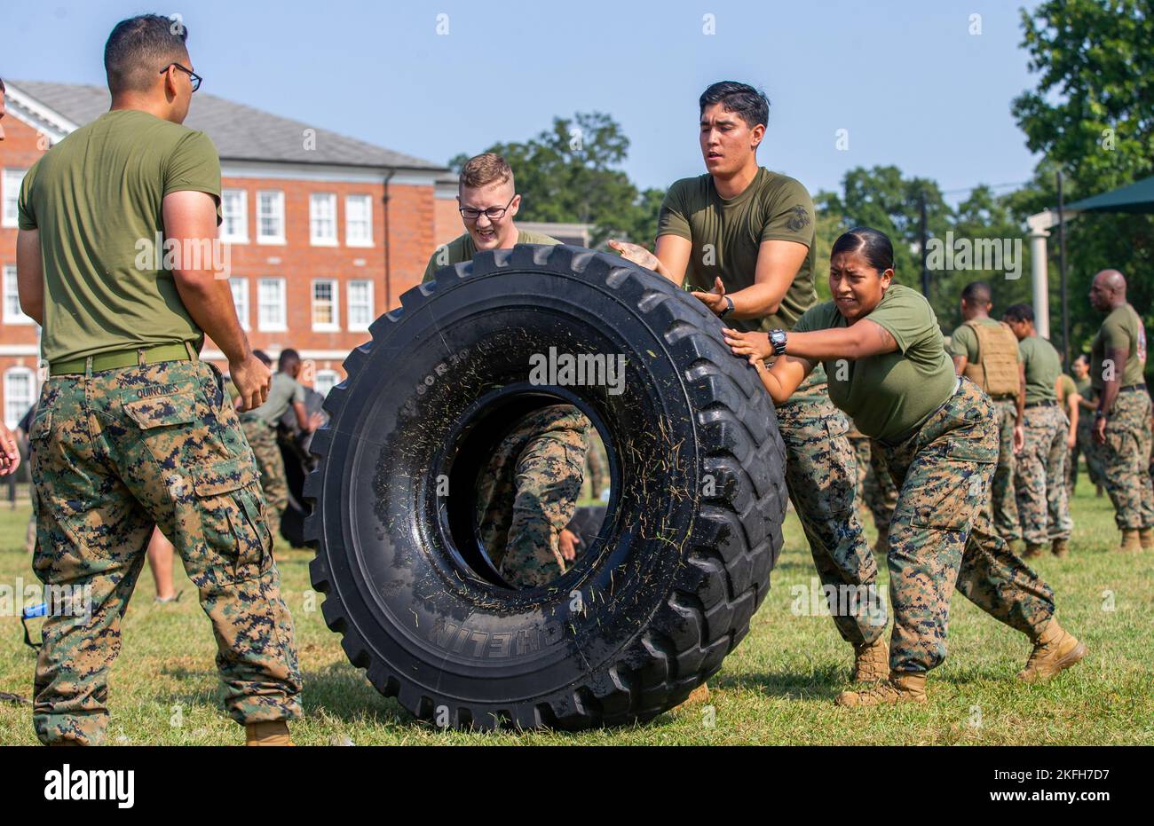 U.S. Marines with Security Battalion participate in a tire flipping ...