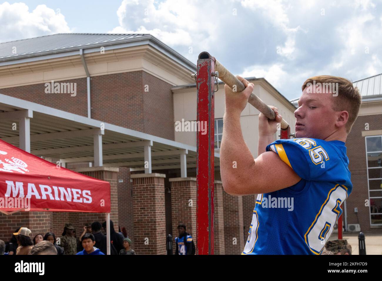 An Oxford High School football player performs pull-ups to contribute ...
