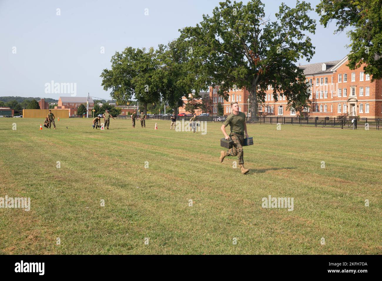 U.S. Marines sprint down the field in an ammo can relay race during the ...