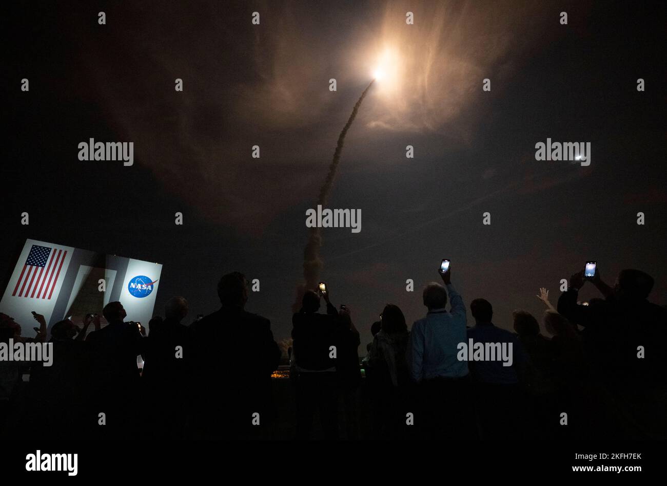 Guests watch the launch of NASAÕs Space Launch System rocket carrying ...