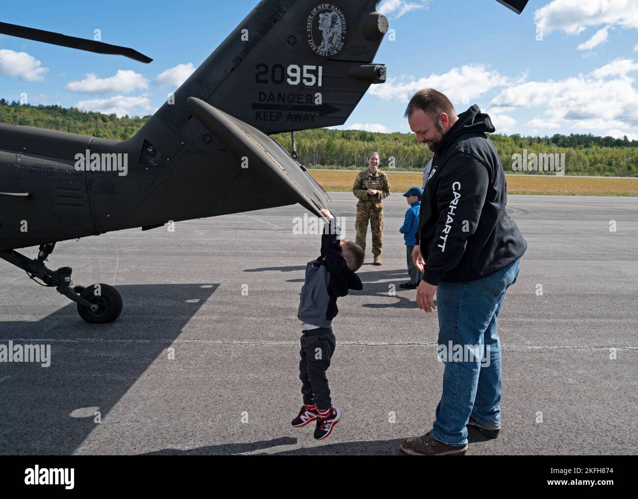 Ryker Guitard dangles from tail of a NHARNG Black Hawk helicopter as ...