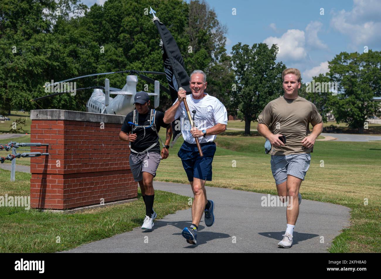 Chris Schack, 19th Airlift Wing chief of protocol, carries a POW/MIA flag during a 24-hour POW ...