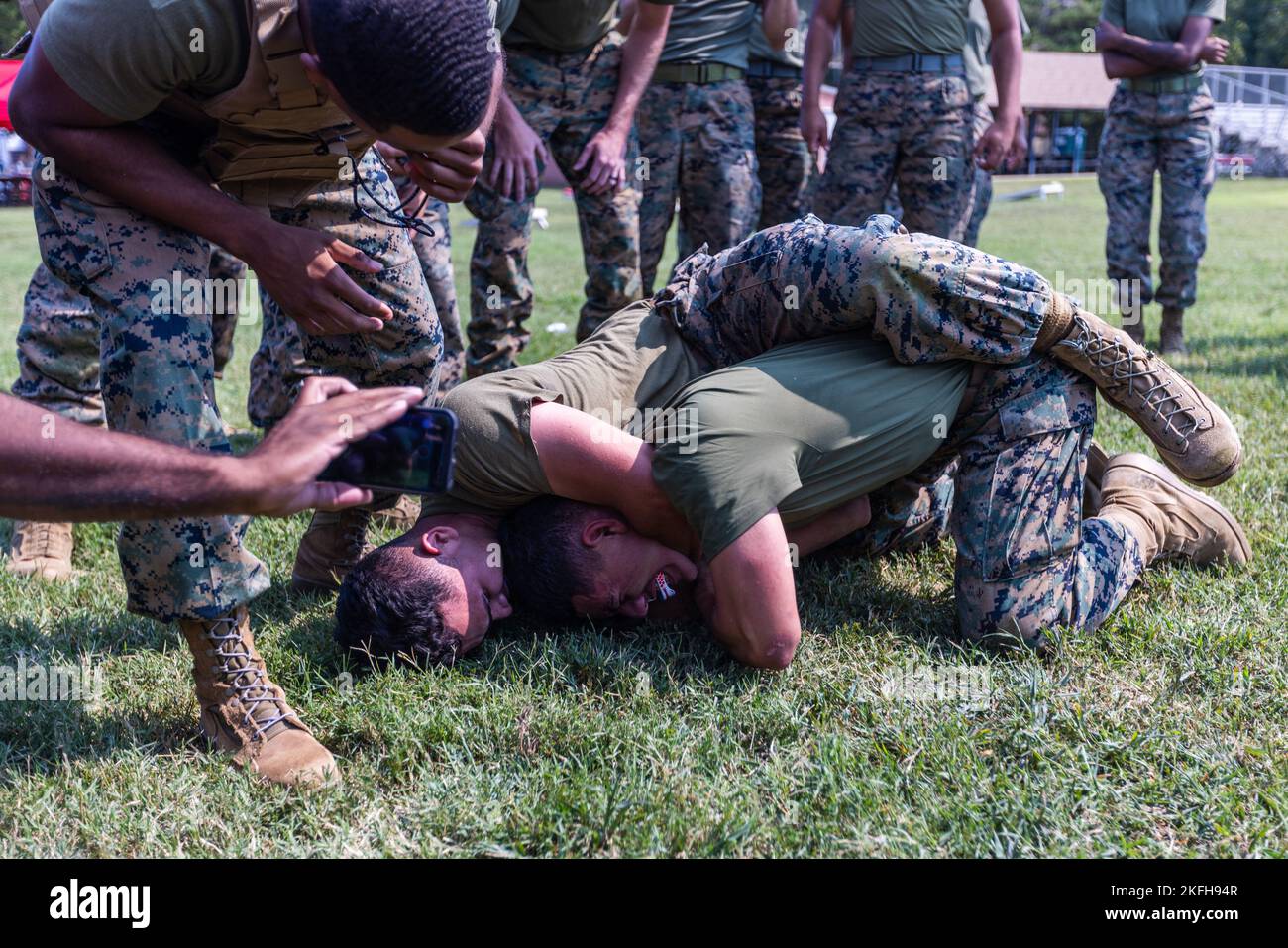 U.S. Marine Corps Cpl. Kendrick Schumacher, top, competes in a ...