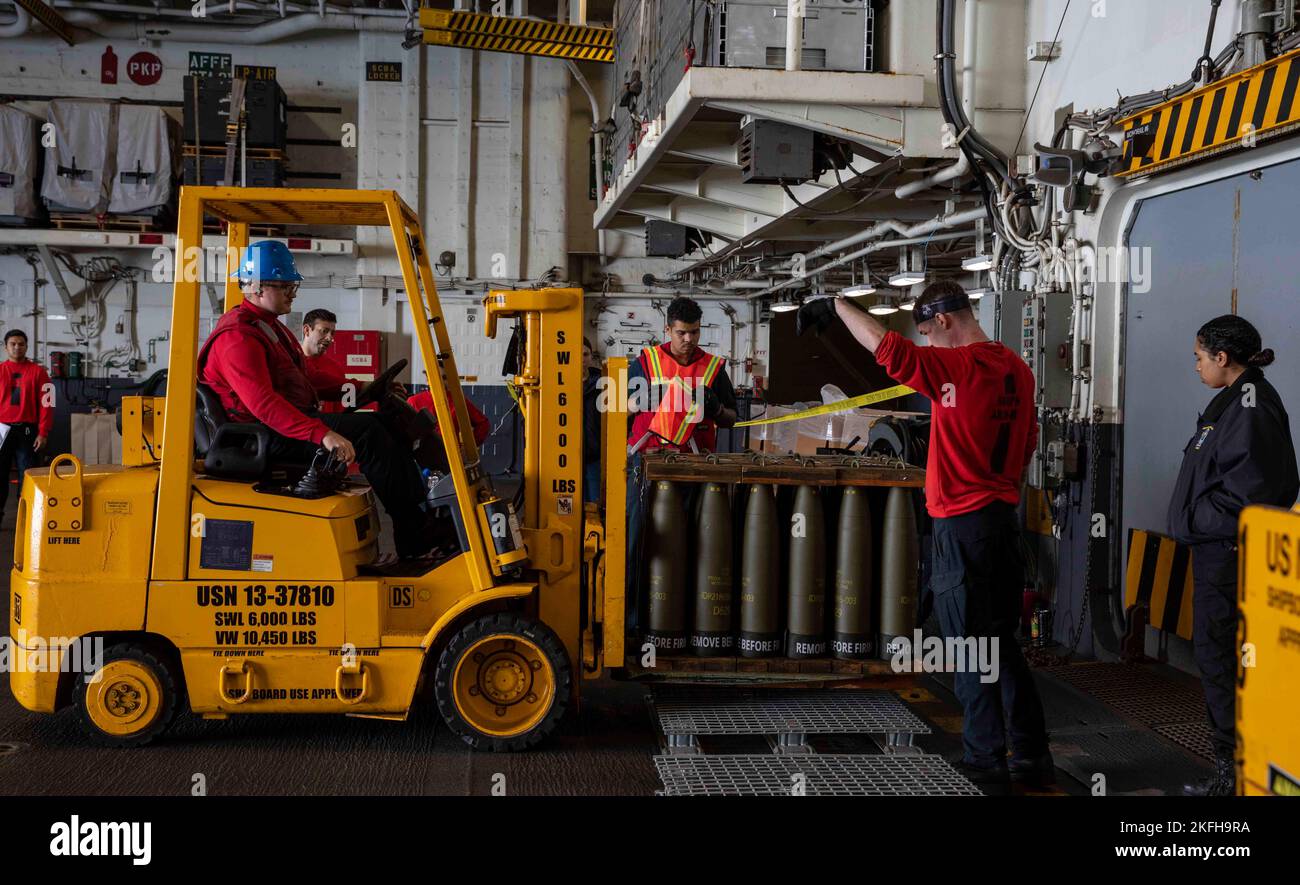 220916-N-DP708-1633 Sailors use a forklift to transport a palette to an ...