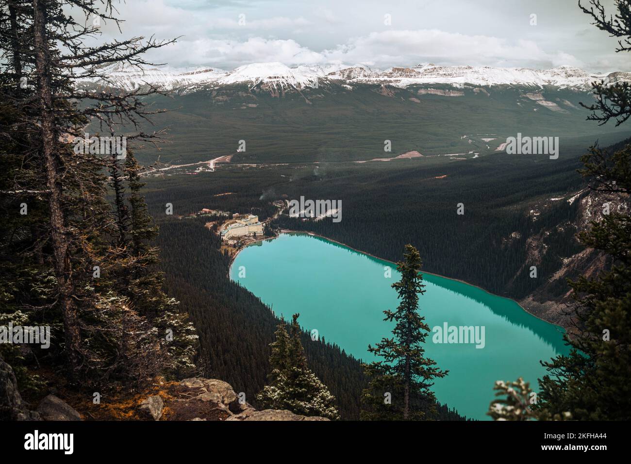 An aerial shot of azure Lake Louise in front of the snowy mountains and ...