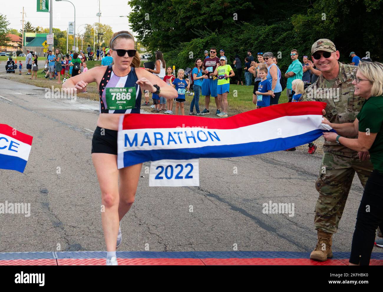 Jenna Henry breaks through the five-kilometer race finishing line ...