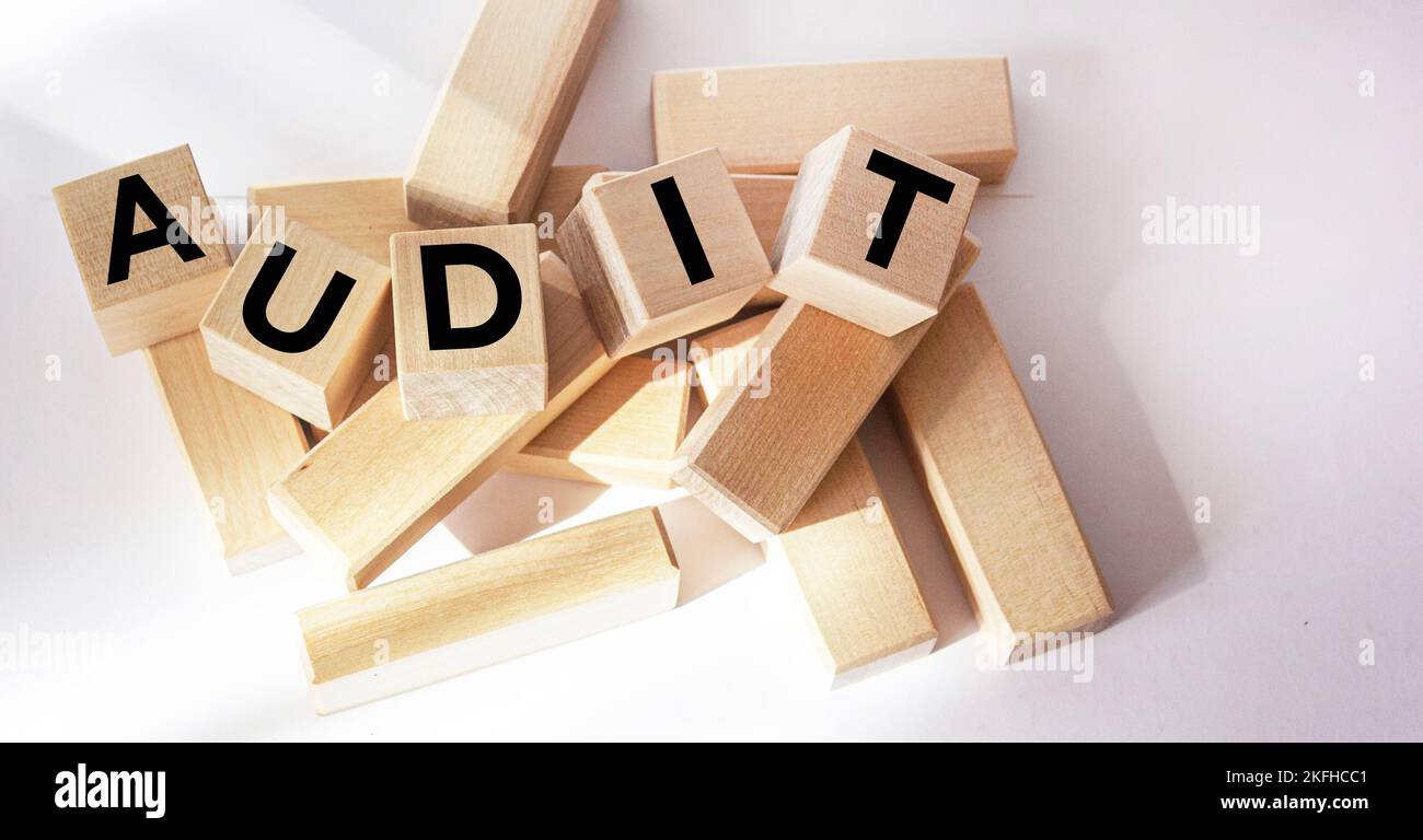 Word Audit text from wooden cubes on white background Stock Photo - Alamy