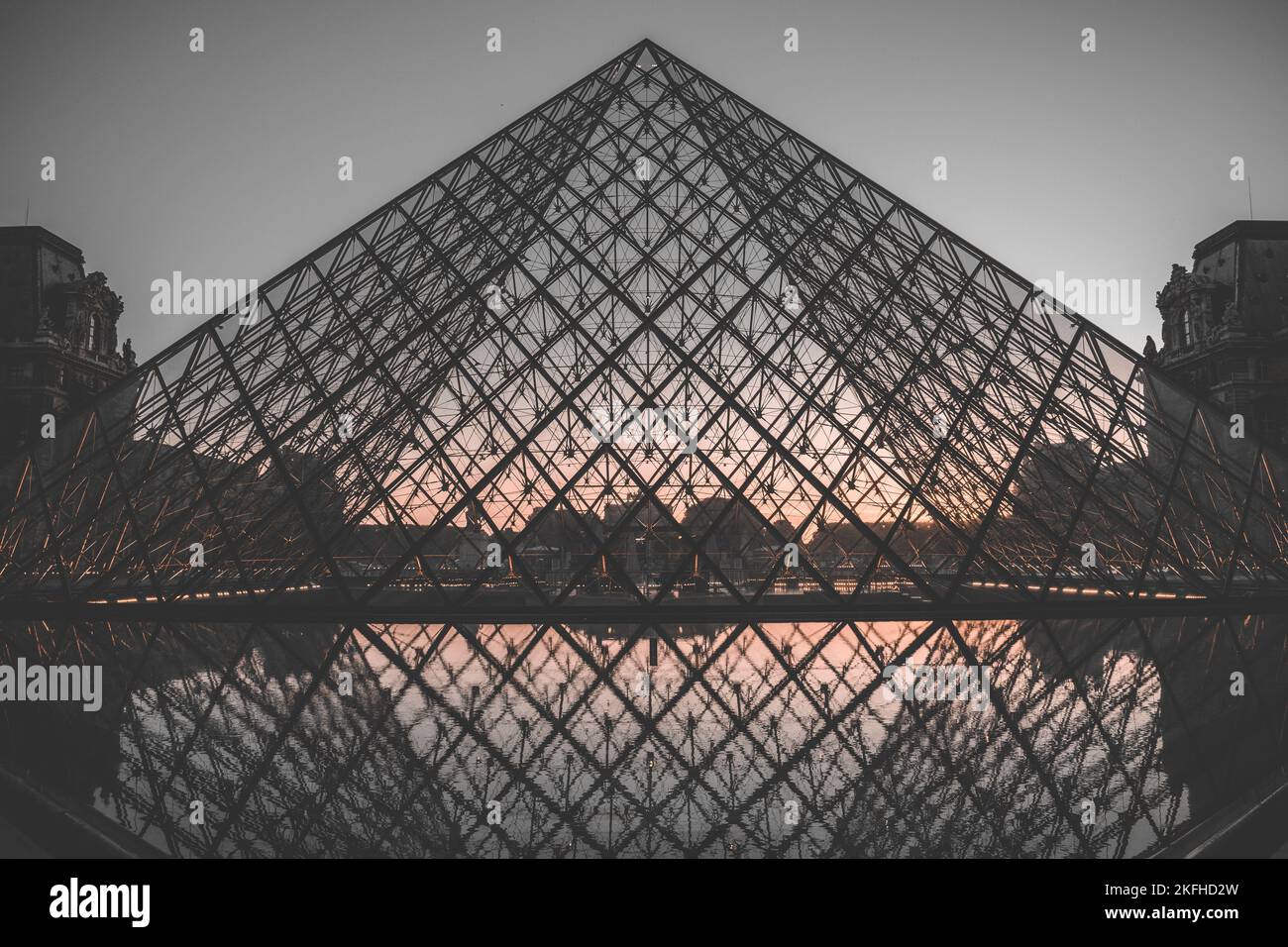 The glass pyramid of museum of Louvre against sunset sky Stock Photo ...
