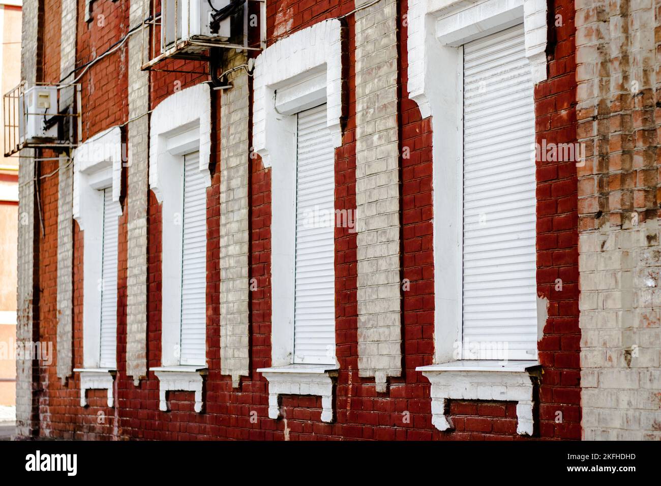 Brick House Windows with rolling shutter for house protection Stock ...