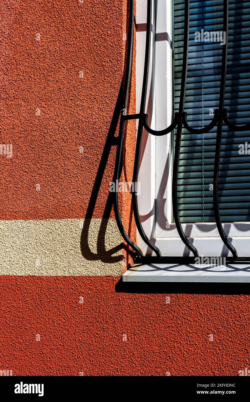 Windows in a wall with figured forged metal bars. Robber protection ...