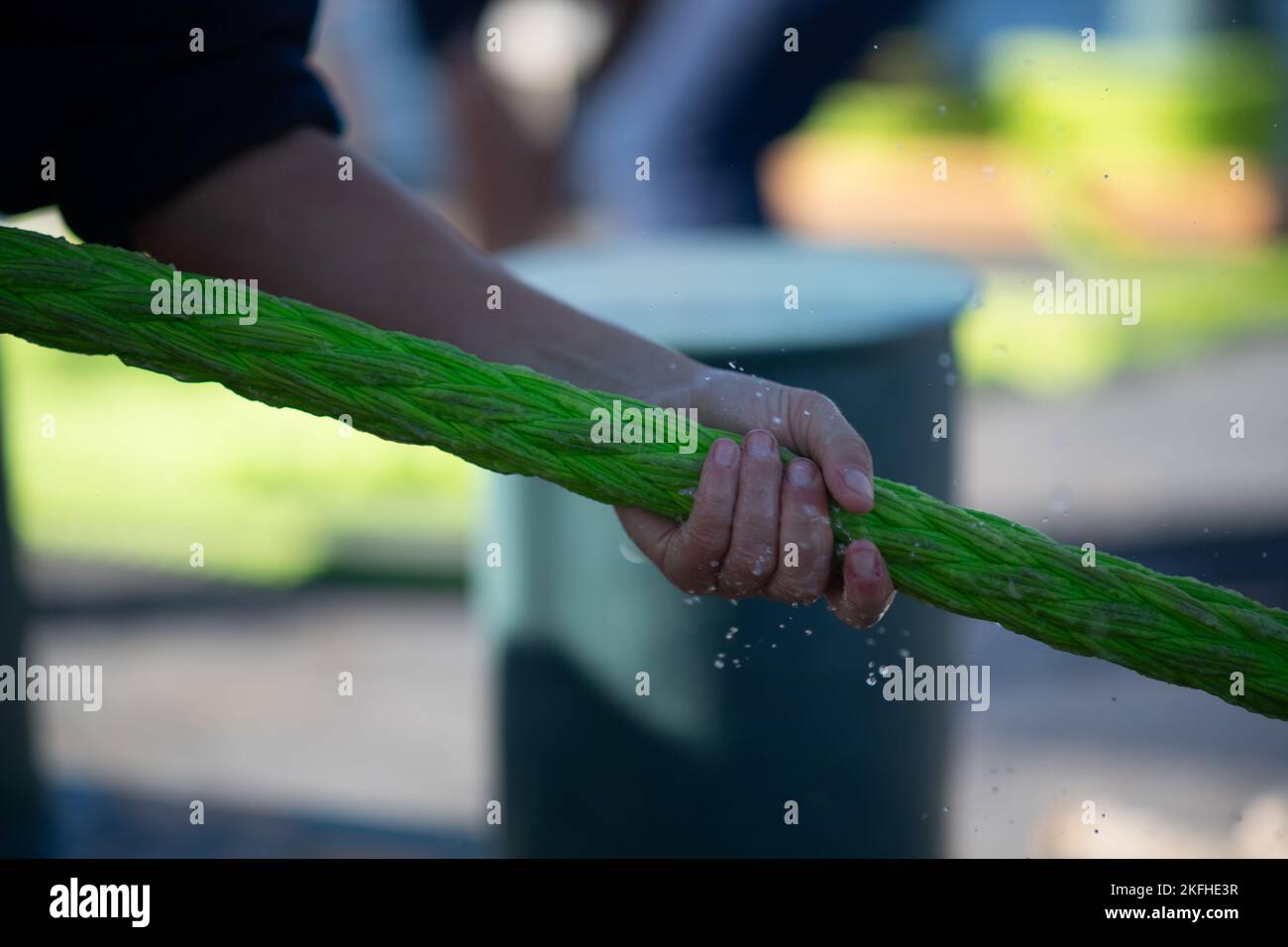 A crew member aboard USCGC Bear (WMEC 901) tend hawser line for the tow ...