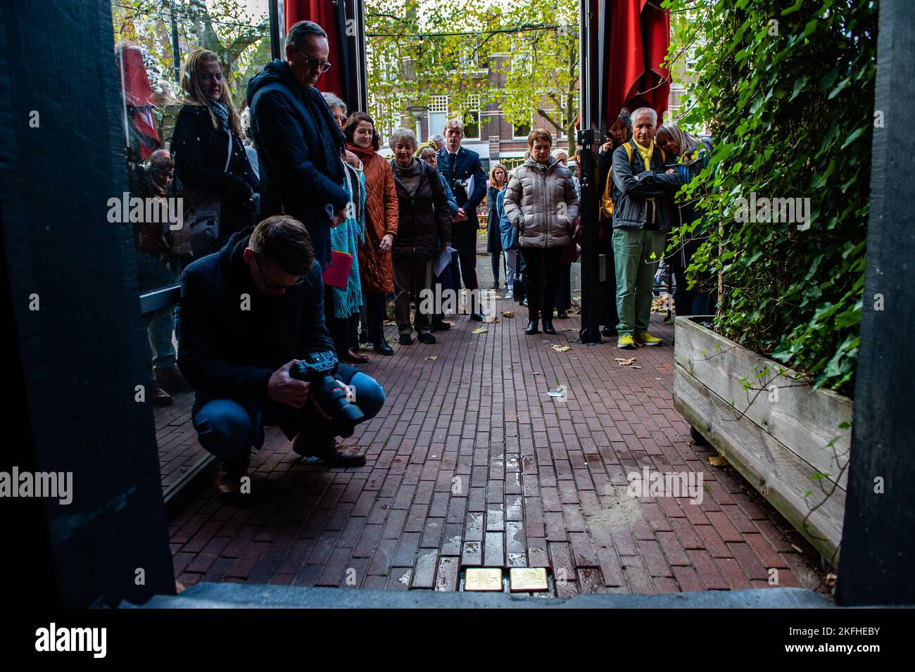 People are seen taking a minute of silence after two Stolpersteine have ...
