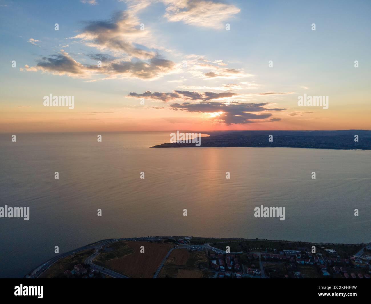 An aerial view of the sea and the coastal town in Istanbul at sunset ...