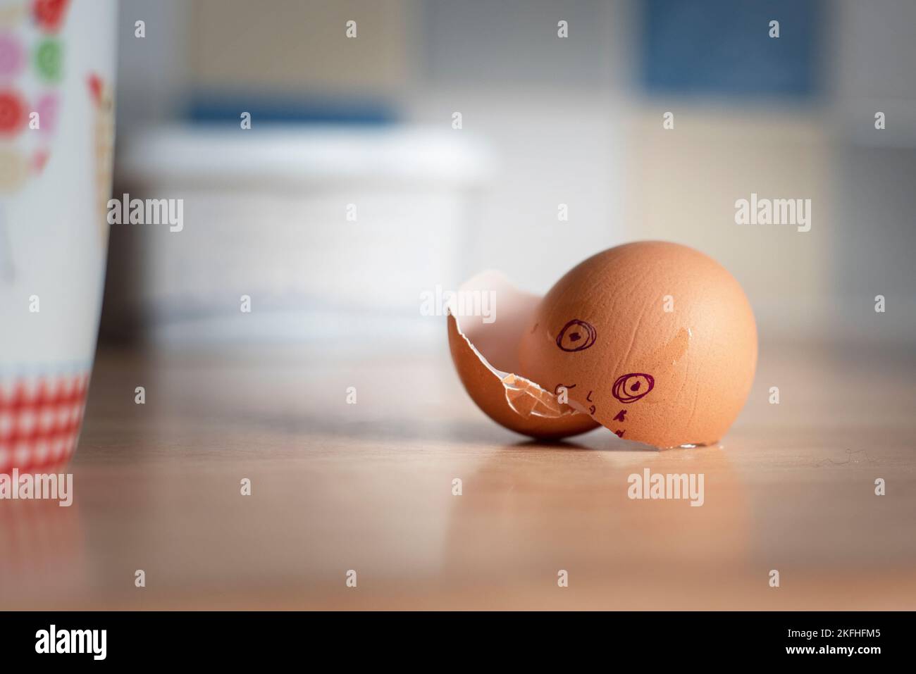 cracked egg shells on the work top with face drawn on the shell Stock ...