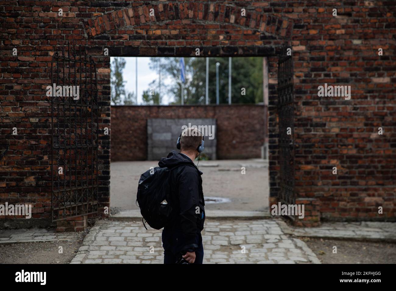 A tourist stands in front of the infamous “death wall” at the memorial ...