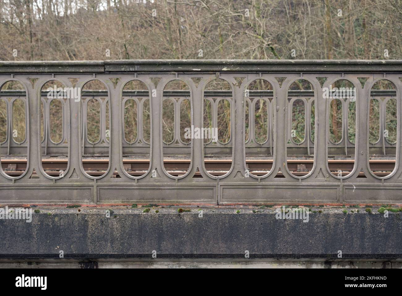 Metal railway bridge with oval openings. Patterned background with ...