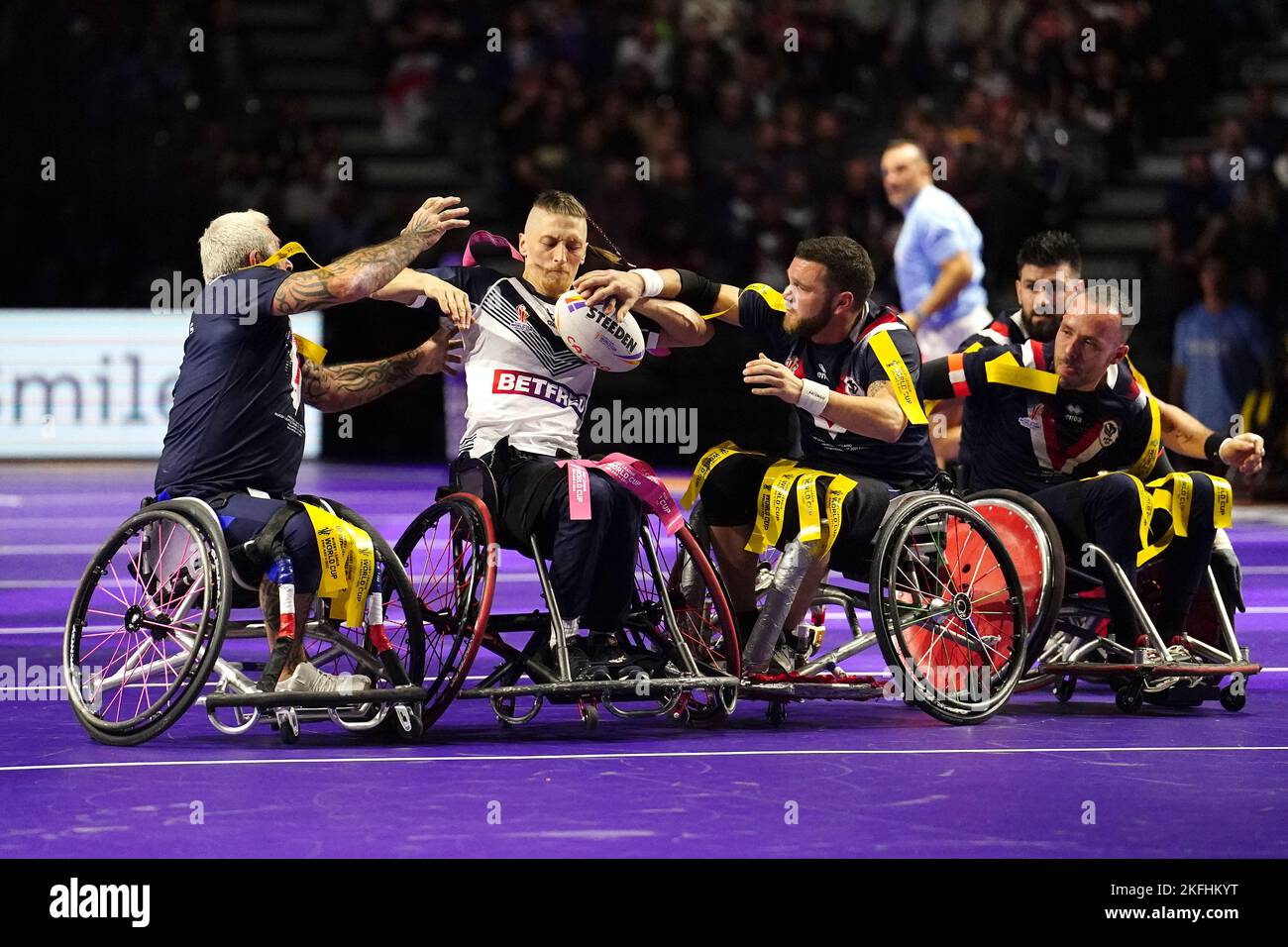 England's Jack Brown (centre) is tackled by France's Gilles Clausells ...