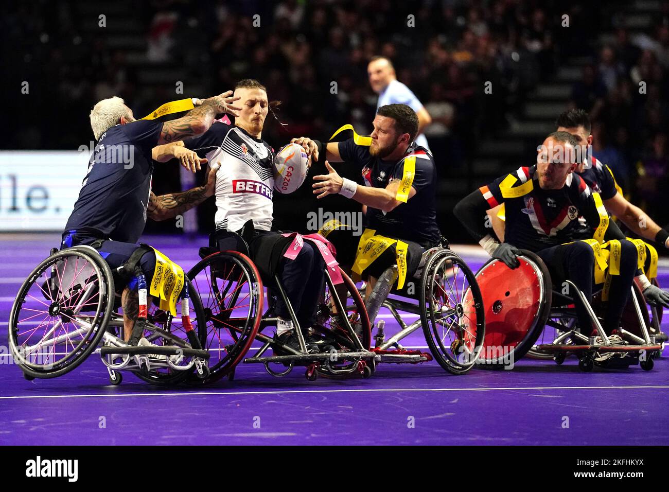 England's Jack Brown (centre) is tackled by France's Gilles Clausells ...